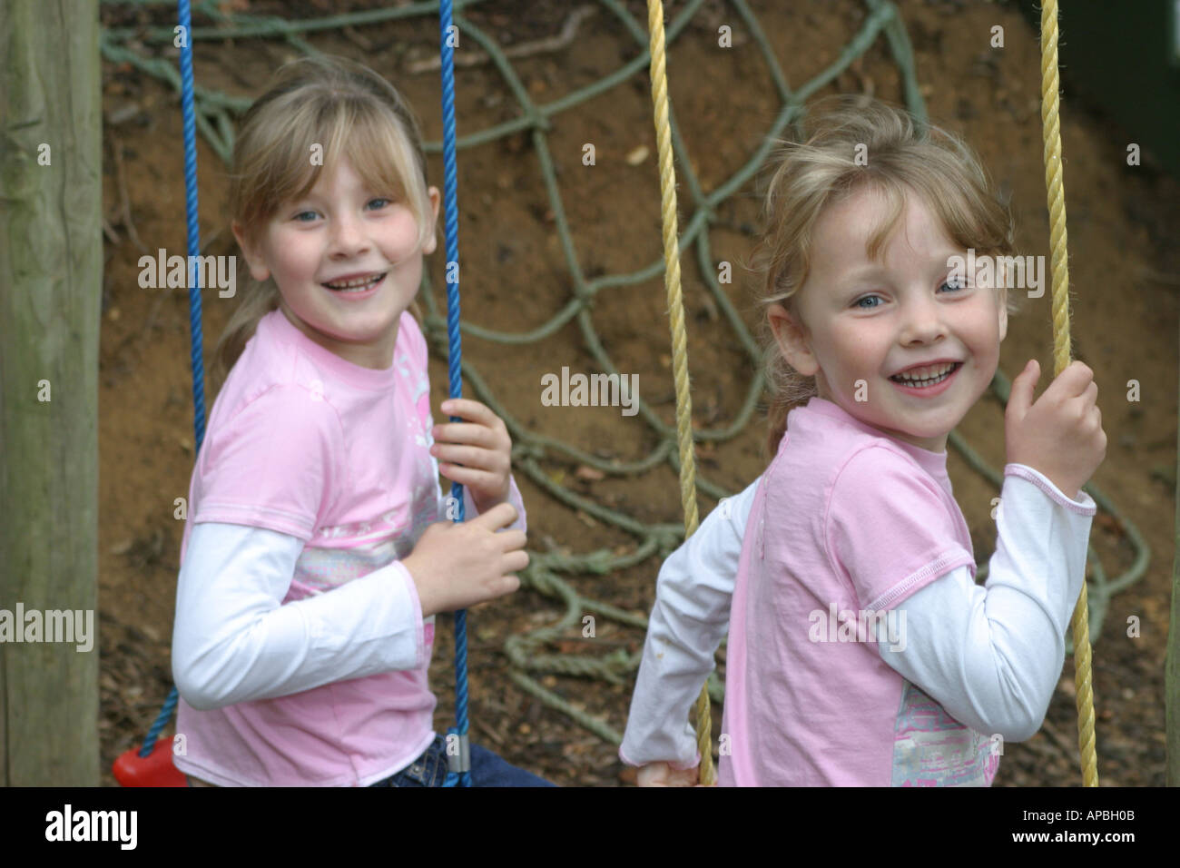 Two girls swinging on swings hi-res stock photography and images - Alamy