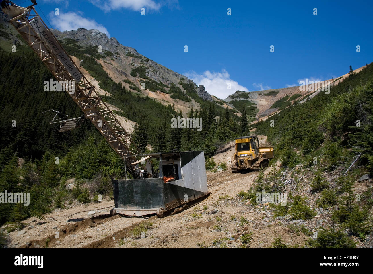 Bulldozer moving diamond drilling rig Astlais mountain BC Stock Photo ...