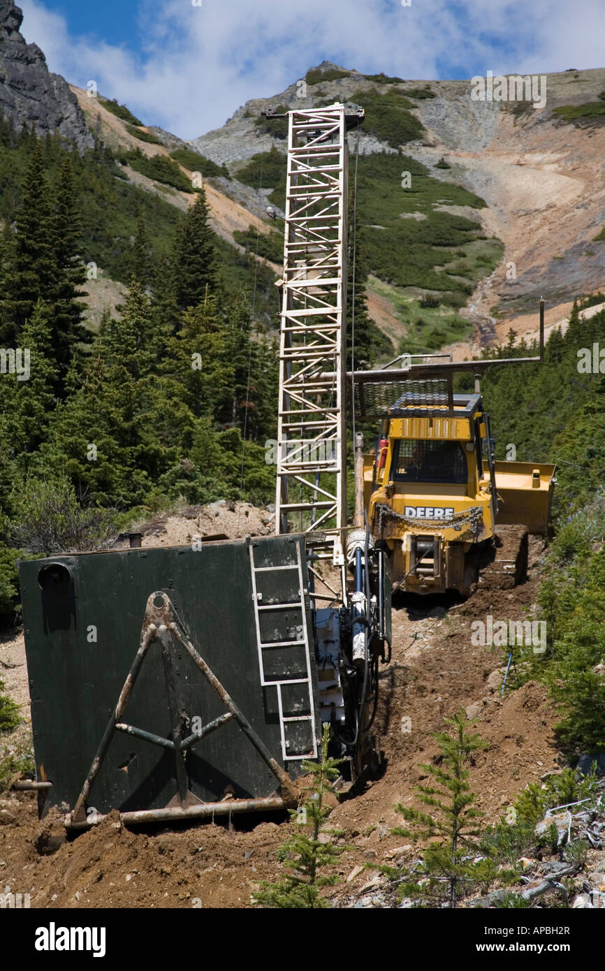 Bulldozer moving diamond drilling rig Astlais mountain BC Stock Photo ...