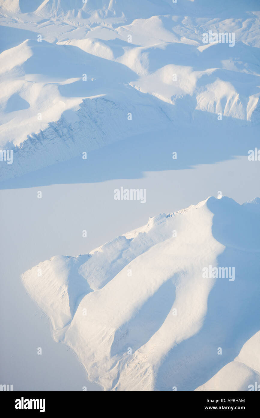 Overhead view from a plane looking down on a remote snow covered frozen ...
