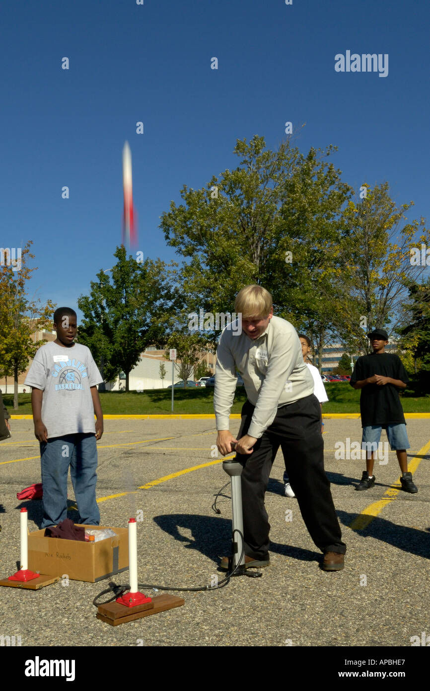 A science teacher launches an air-powered model rocket as his students ...