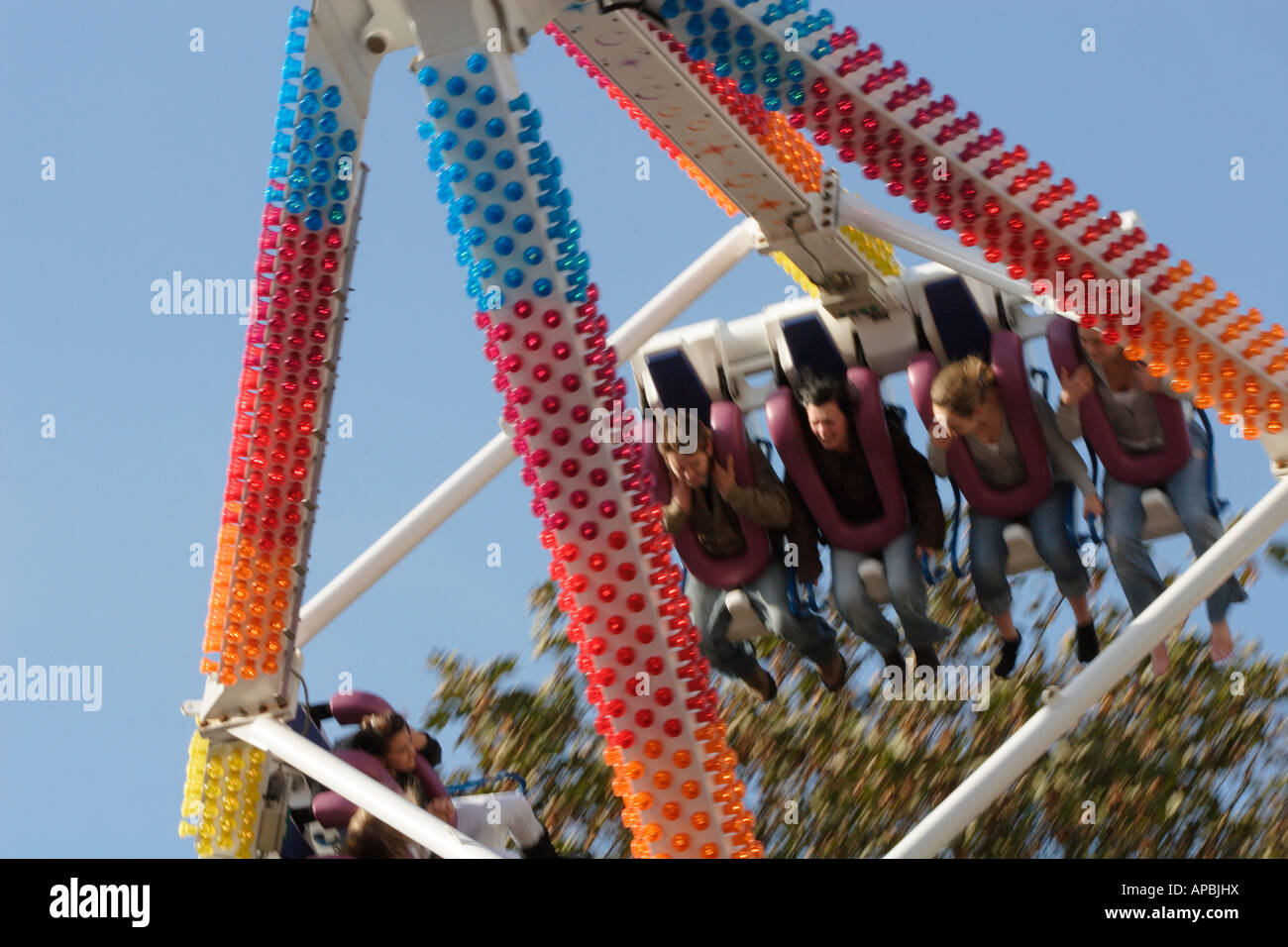 People on a fairground ride, UK (A Freak Out ride, a smaller version of ...