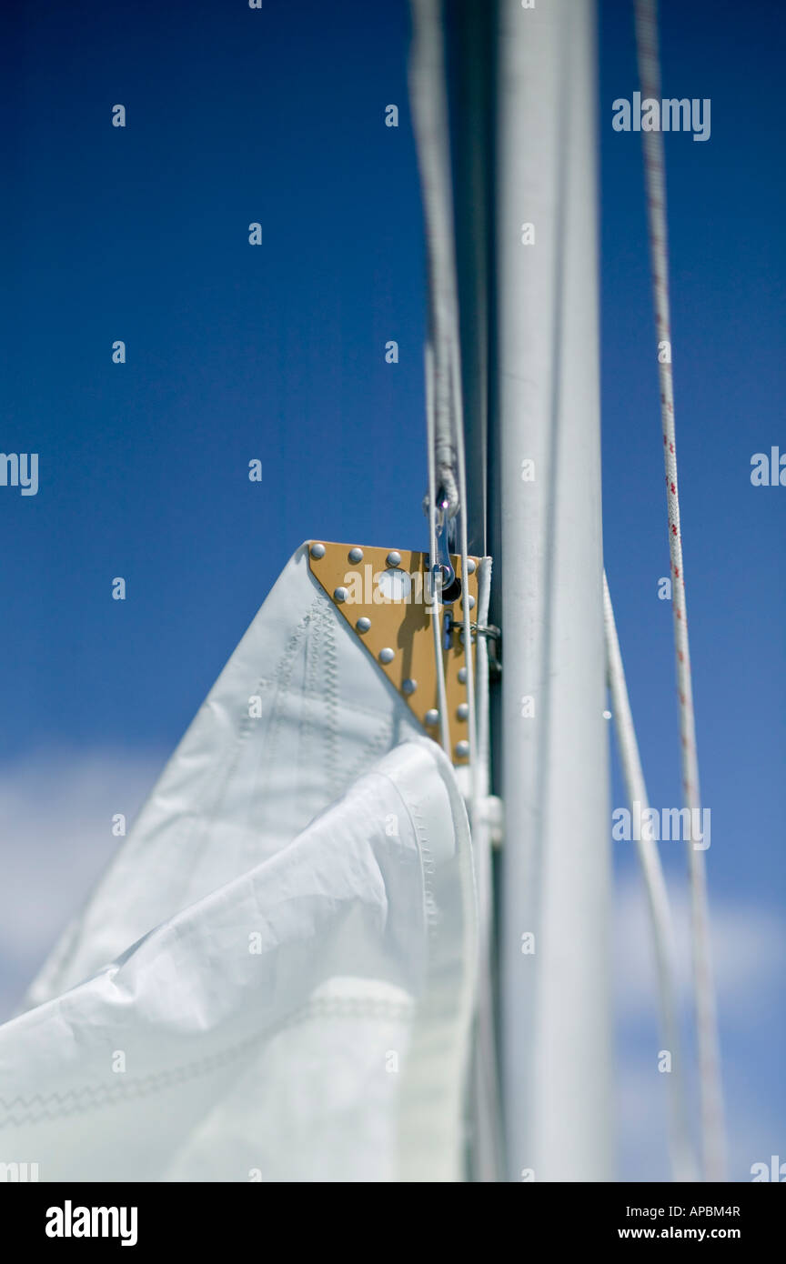 sail on mast of sailboat ready to hoist up with halyard Stock Photo - Alamy