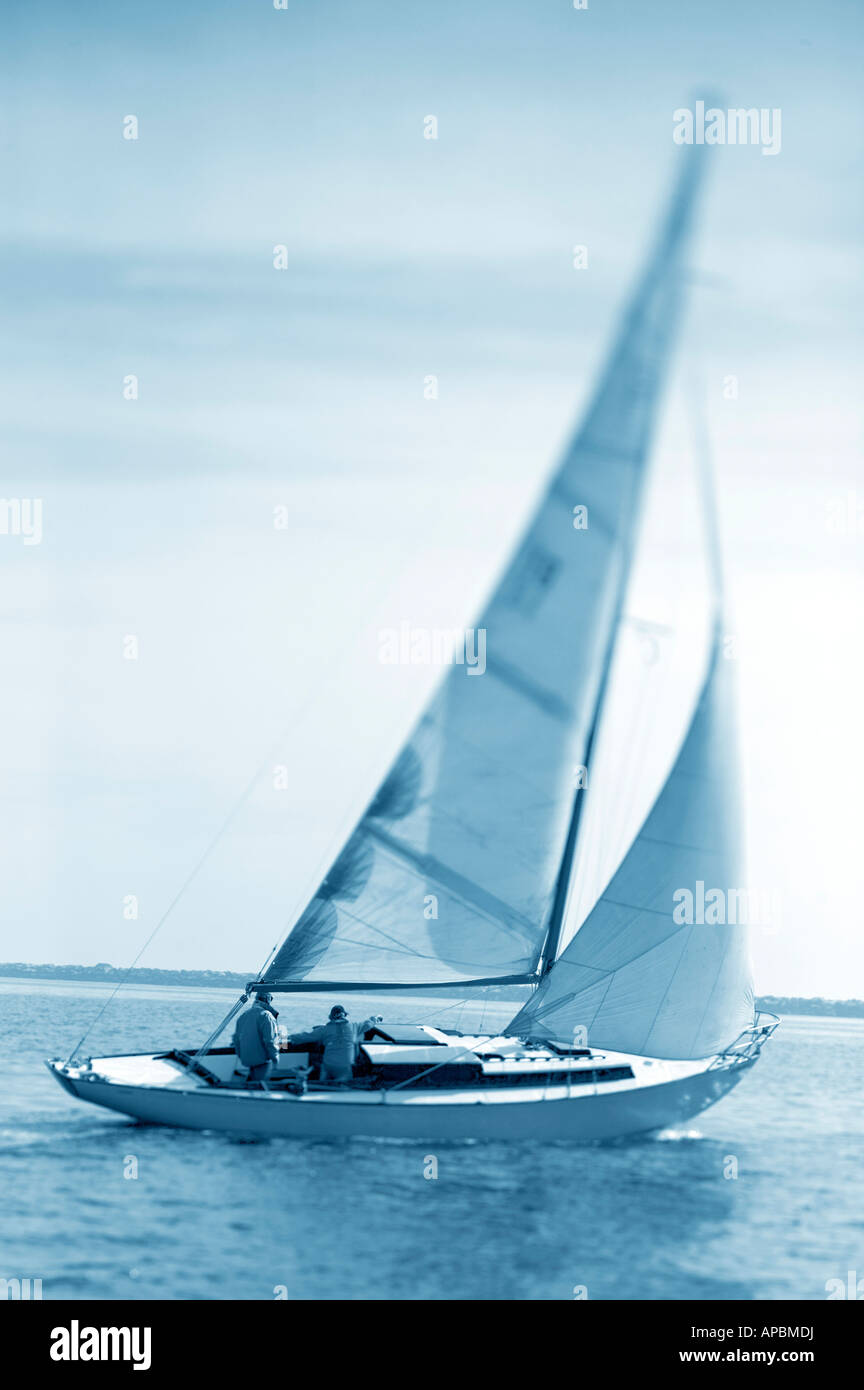 blue sailboat under sail in calm seas and light wind sailing Stock ...