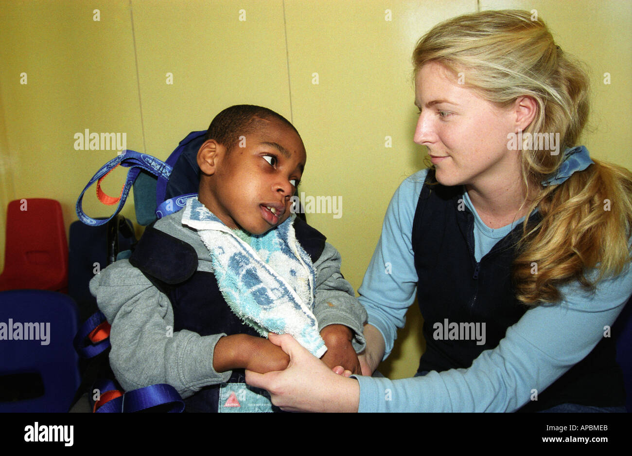 Autistic child with carer at a special school, Southwark, London, UK ...