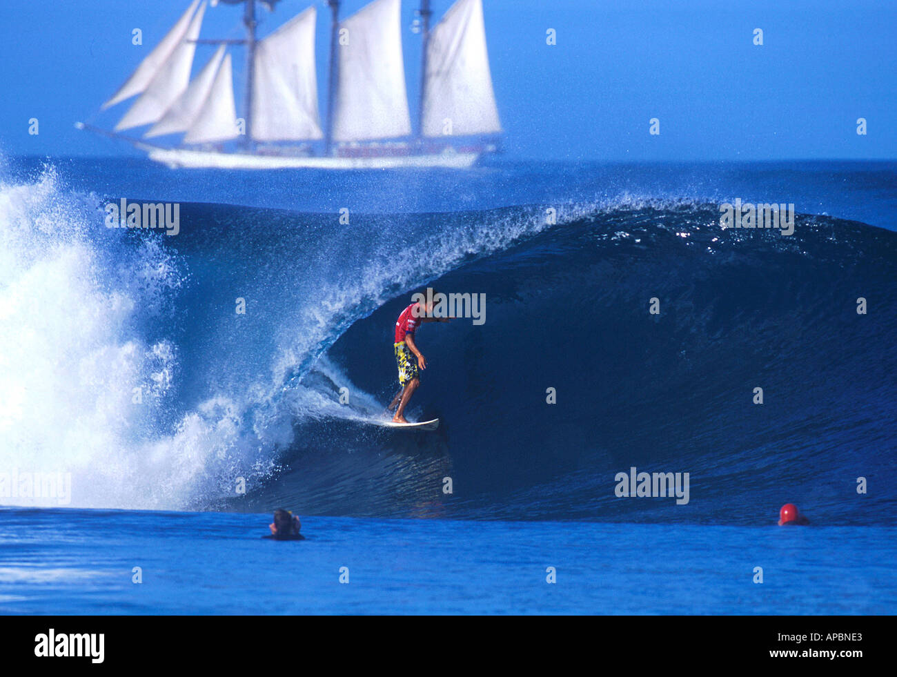 Surfer on wave with tall ship sailing on horizon, Rob Machado, Pipe ...