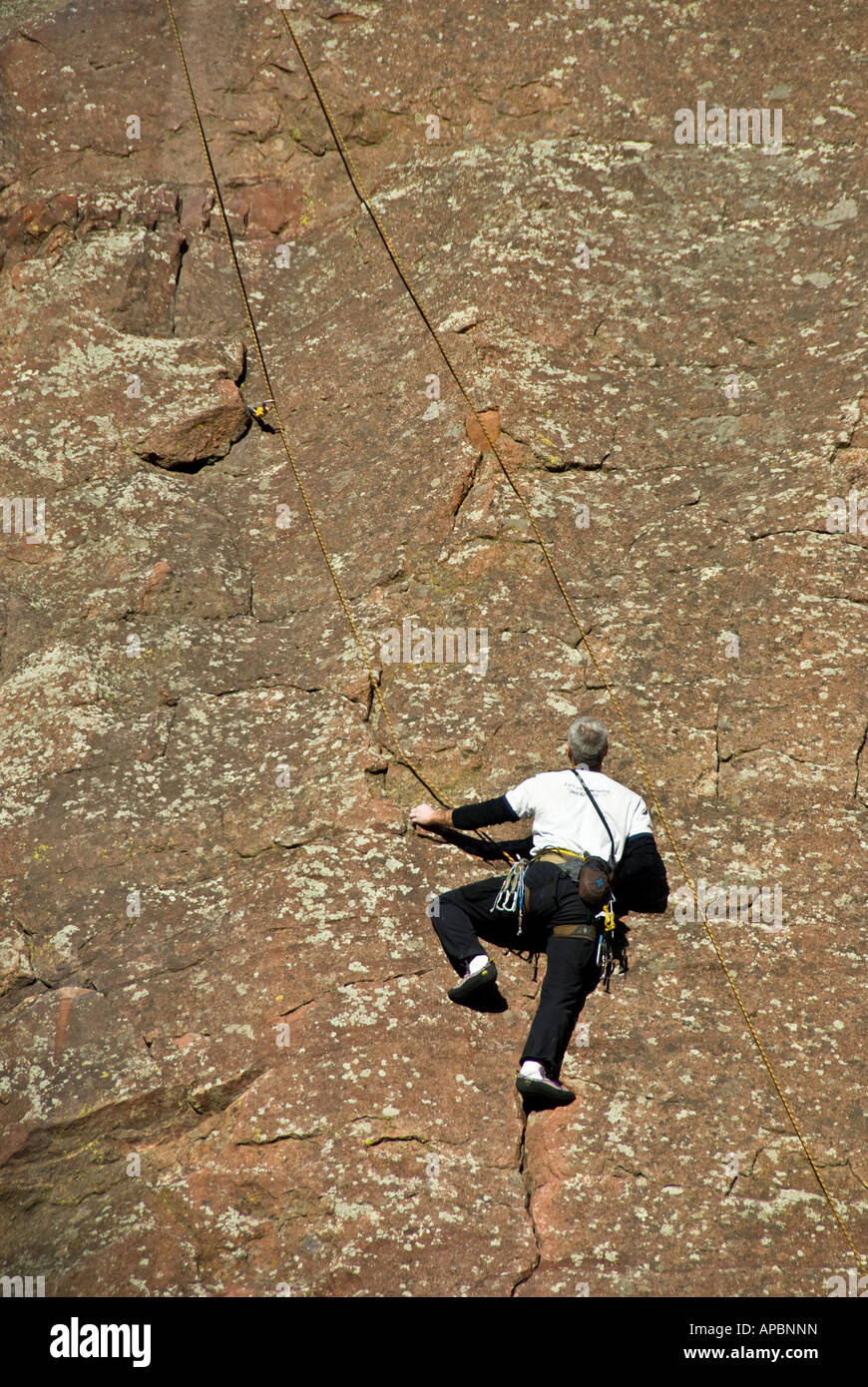 Rock climber on steep face, climbing with ropes Stock Photo - Alamy