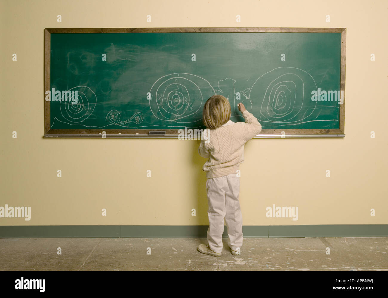 young boy writes with chalk on large horizontal chalk board ideas ...