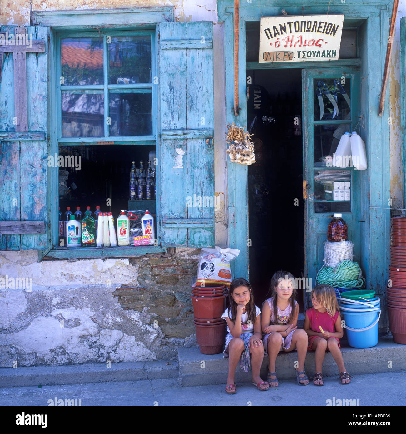 CHILDREN SITTING OUTSIDE A GREEK SHOP Stock Photo - Alamy