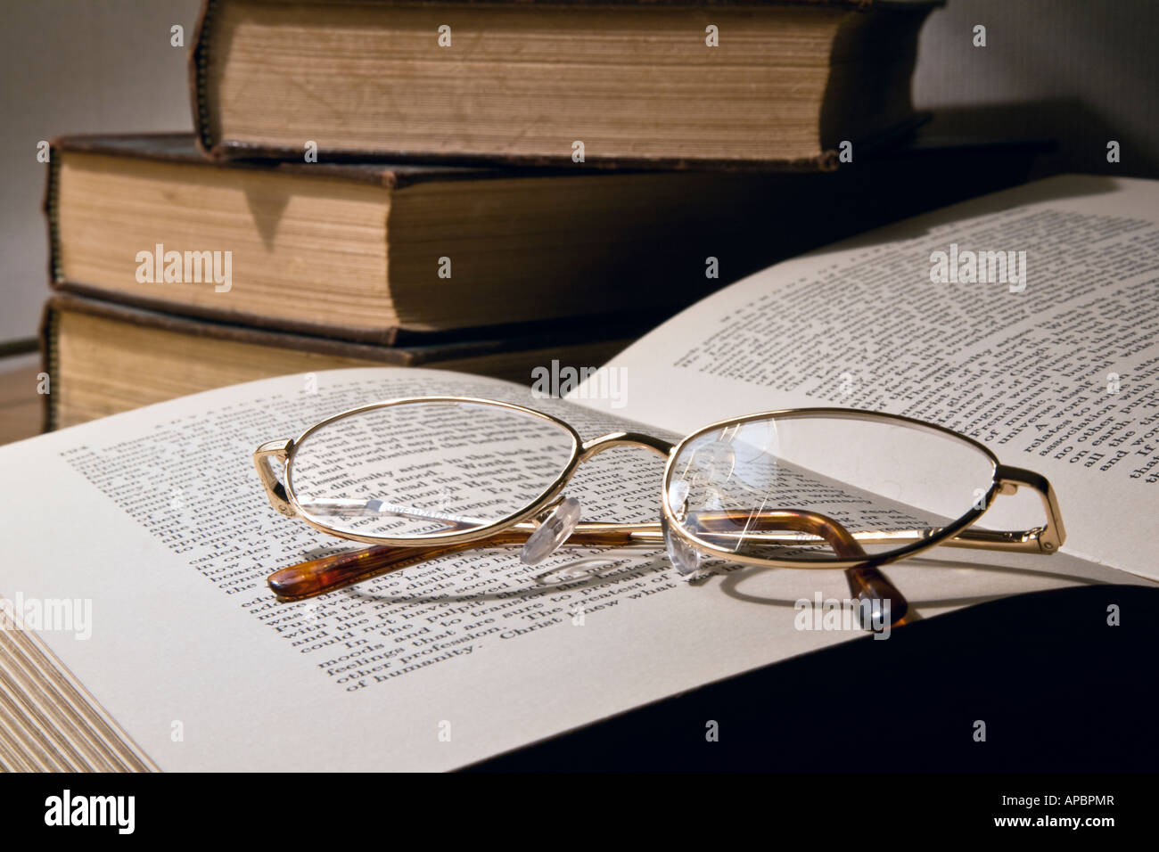 A pair of glasses on an open page of a book Stock Photo - Alamy