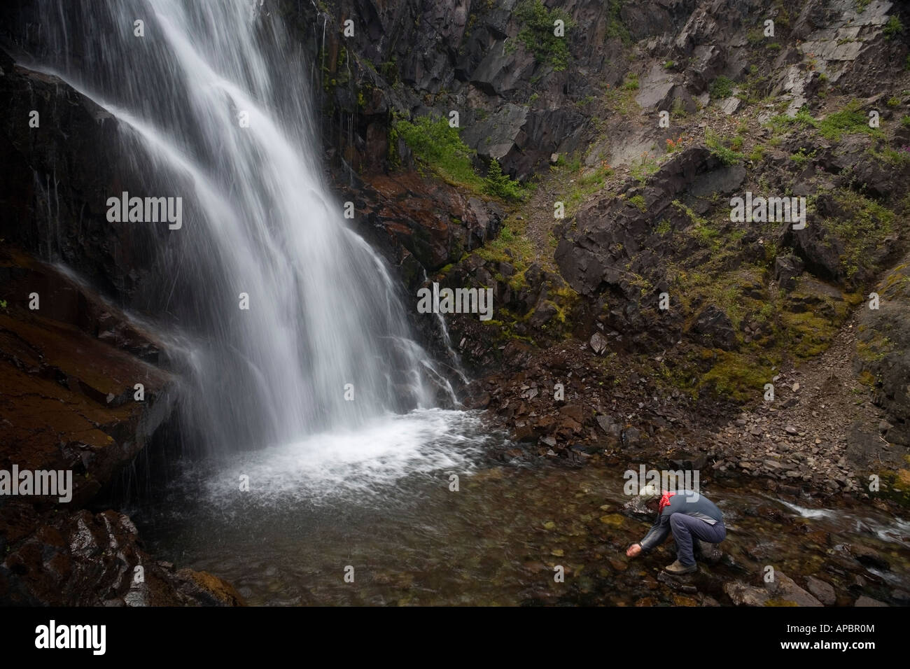 Hiker below waterfall Hunters Basin Telkwa Mountains BC Stock Photo - Alamy