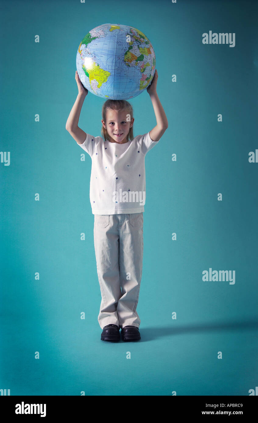 Girl holding globe over her head Stock Photo - Alamy