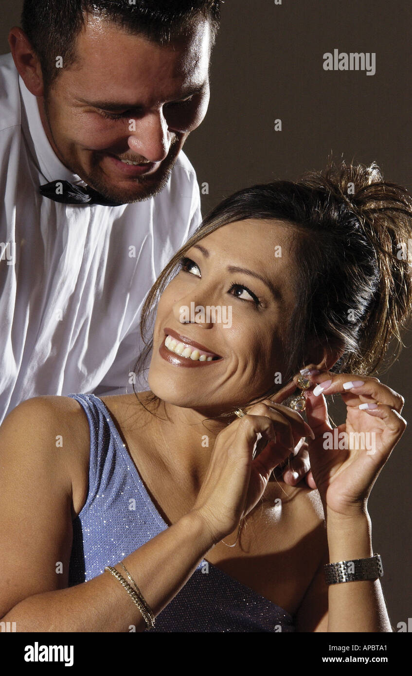 Couple getting ready for an evening out Stock Photo - Alamy