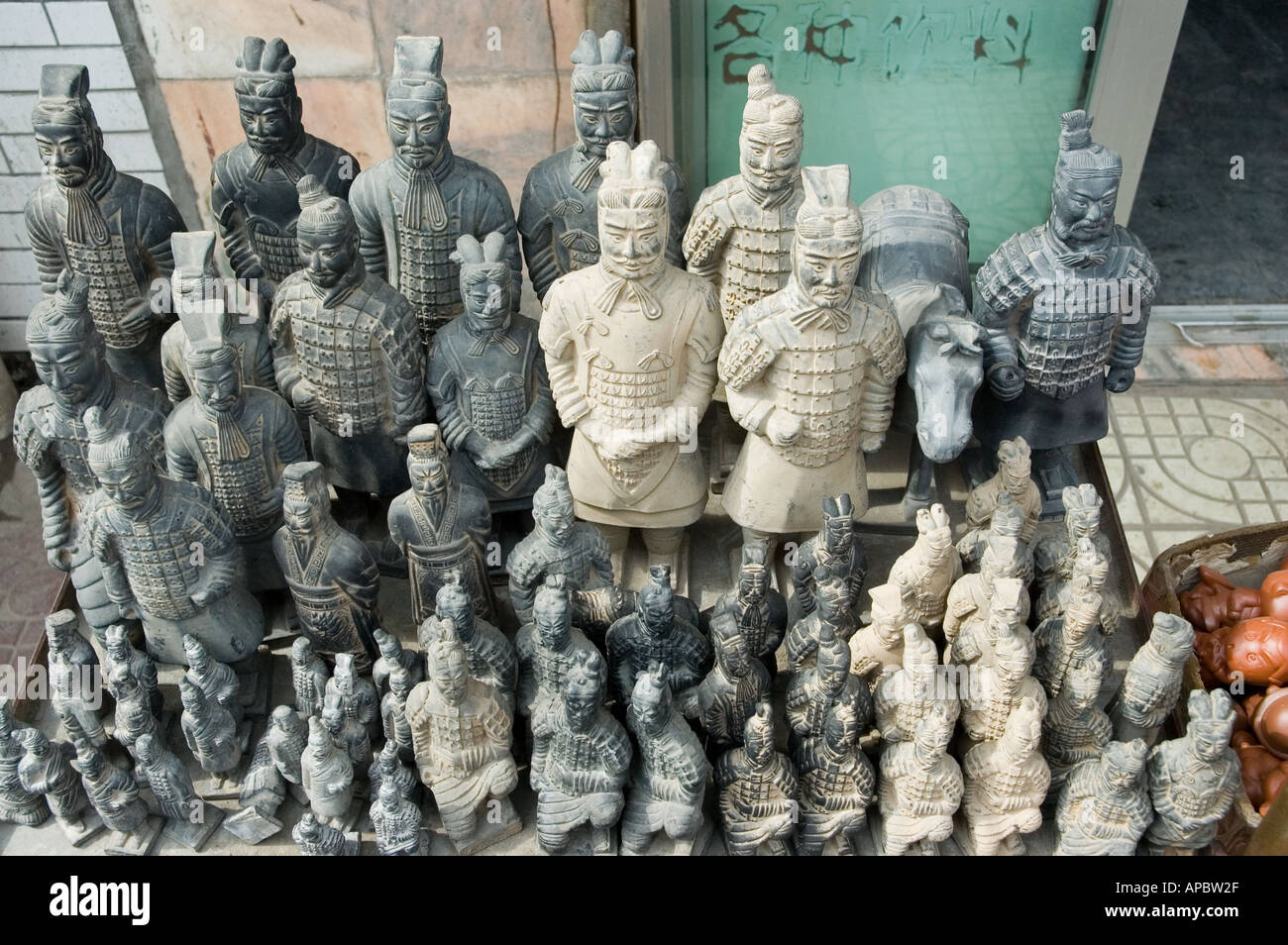 Miniature terracotta warriors in neat display at market stall, Xian ...