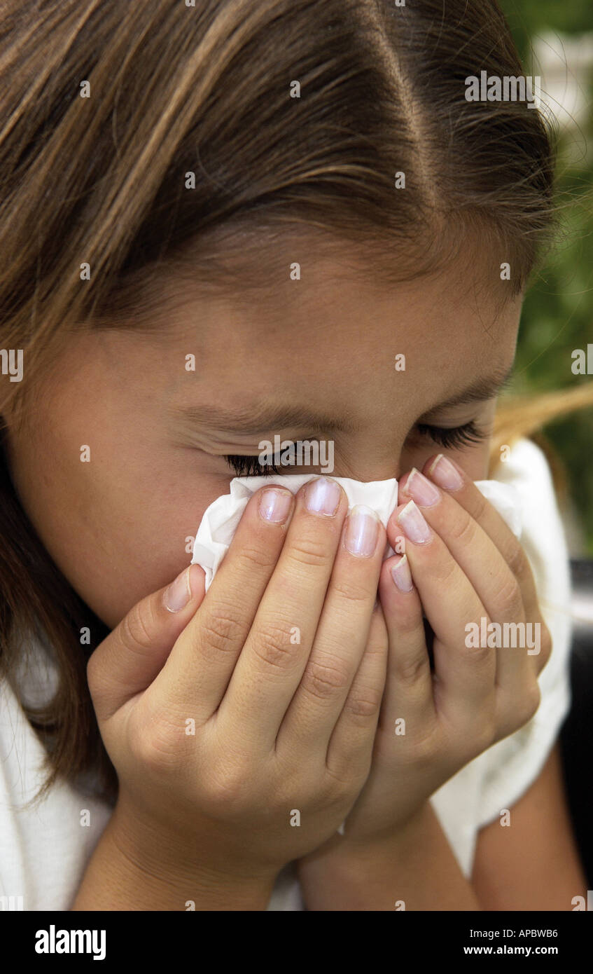 Young girl sneezing Stock Photo - Alamy