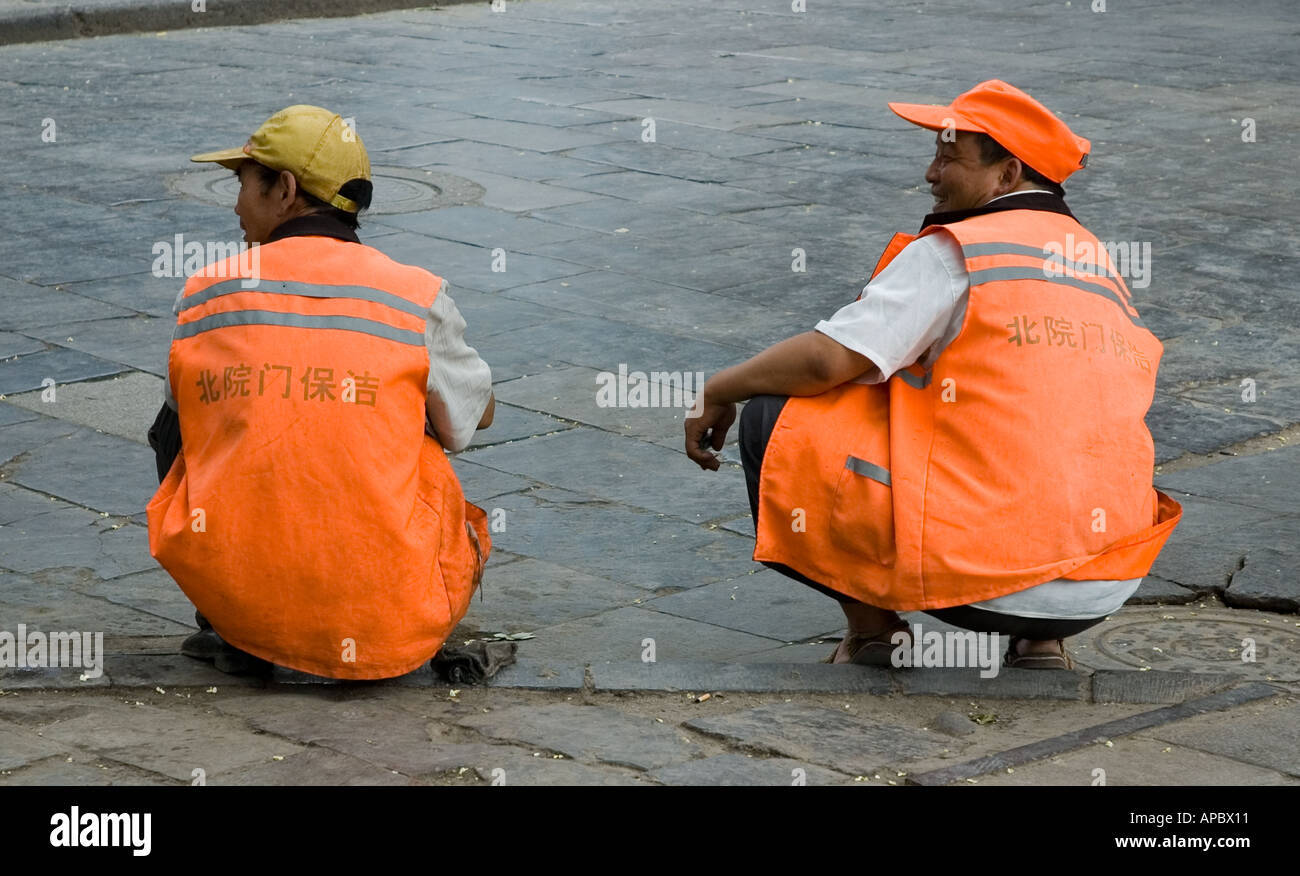Chinese workmen resting in squatting position Stock Photo - Alamy