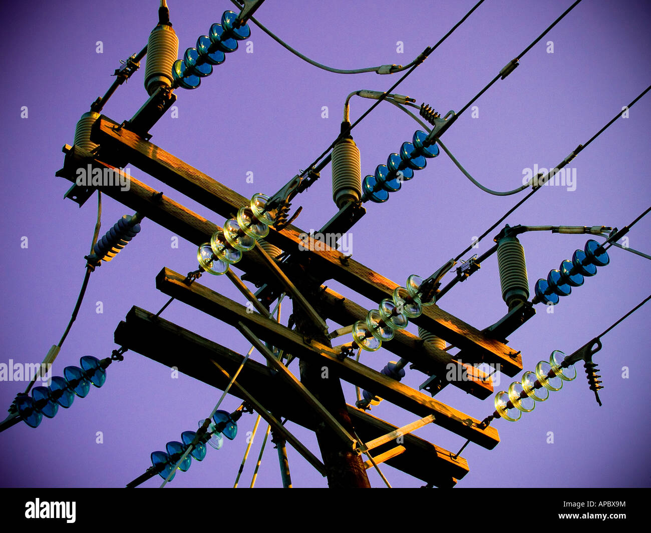 A wooden electricity pole carrying a live high-voltage installation ...