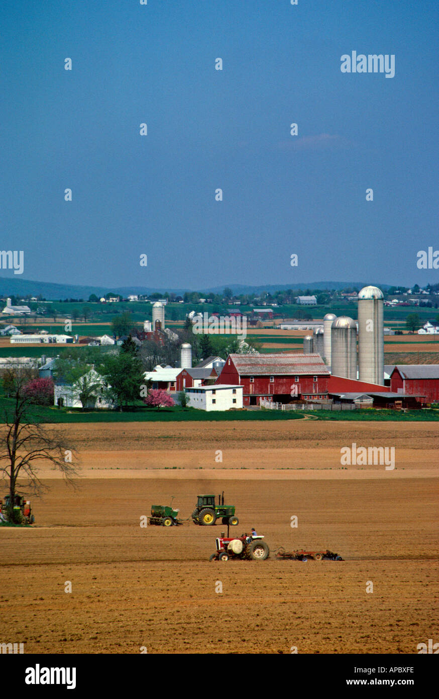 Farmers discing and planting corn on farm in spring near Manheim ...