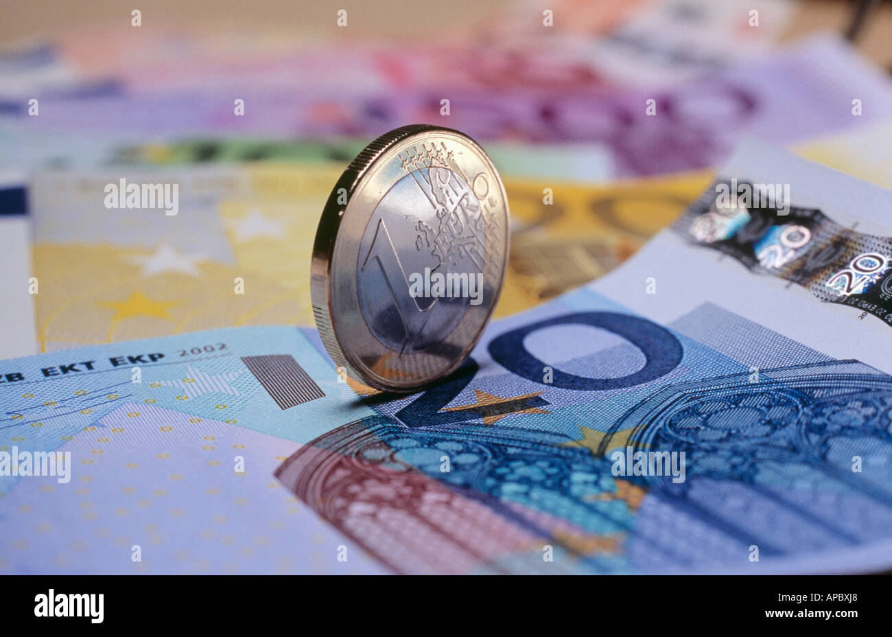 1-Euro coin standing on Euro notes Stock Photo - Alamy