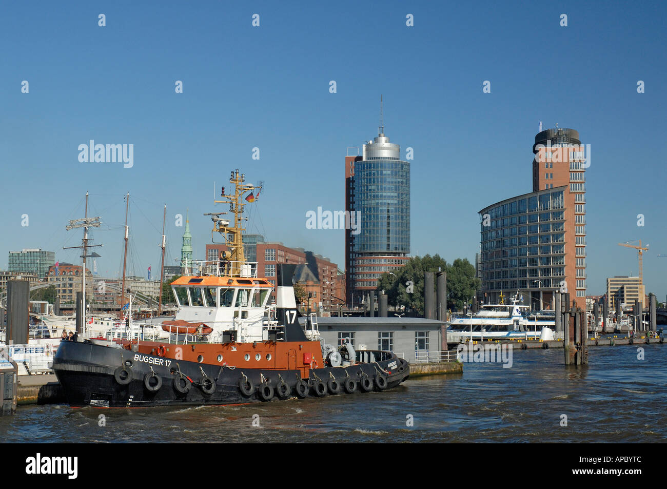 Tag boat lying in front of the modern office buildings of Hanseatic ...