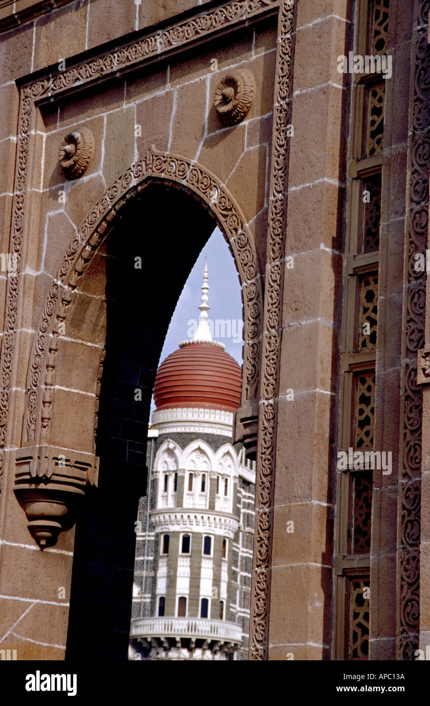 A spire of the Taj Hotel in Mumbai peaks through the Gateway of India ...
