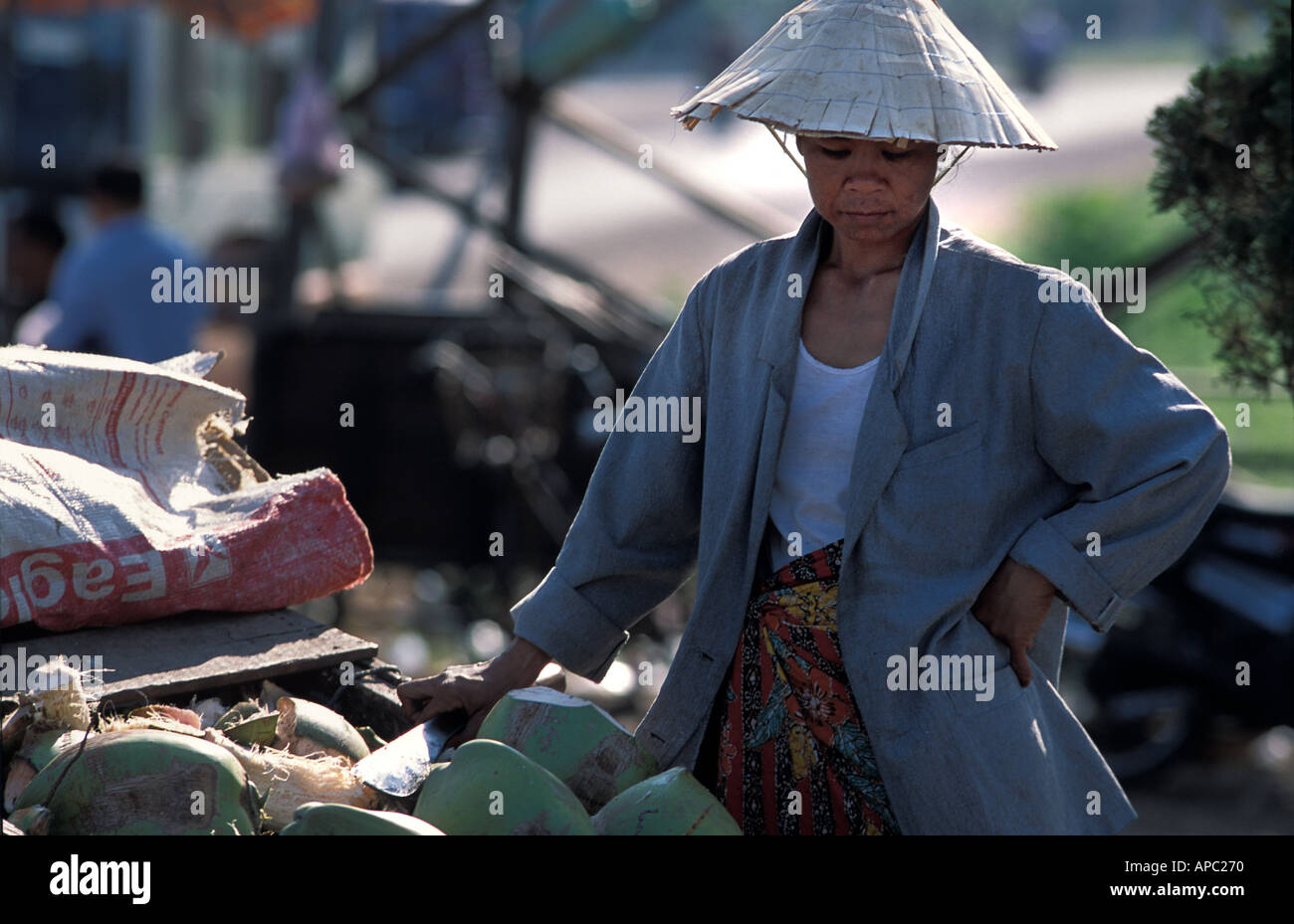 Market trader in conical hat central market by bus terminal Vientiane ...