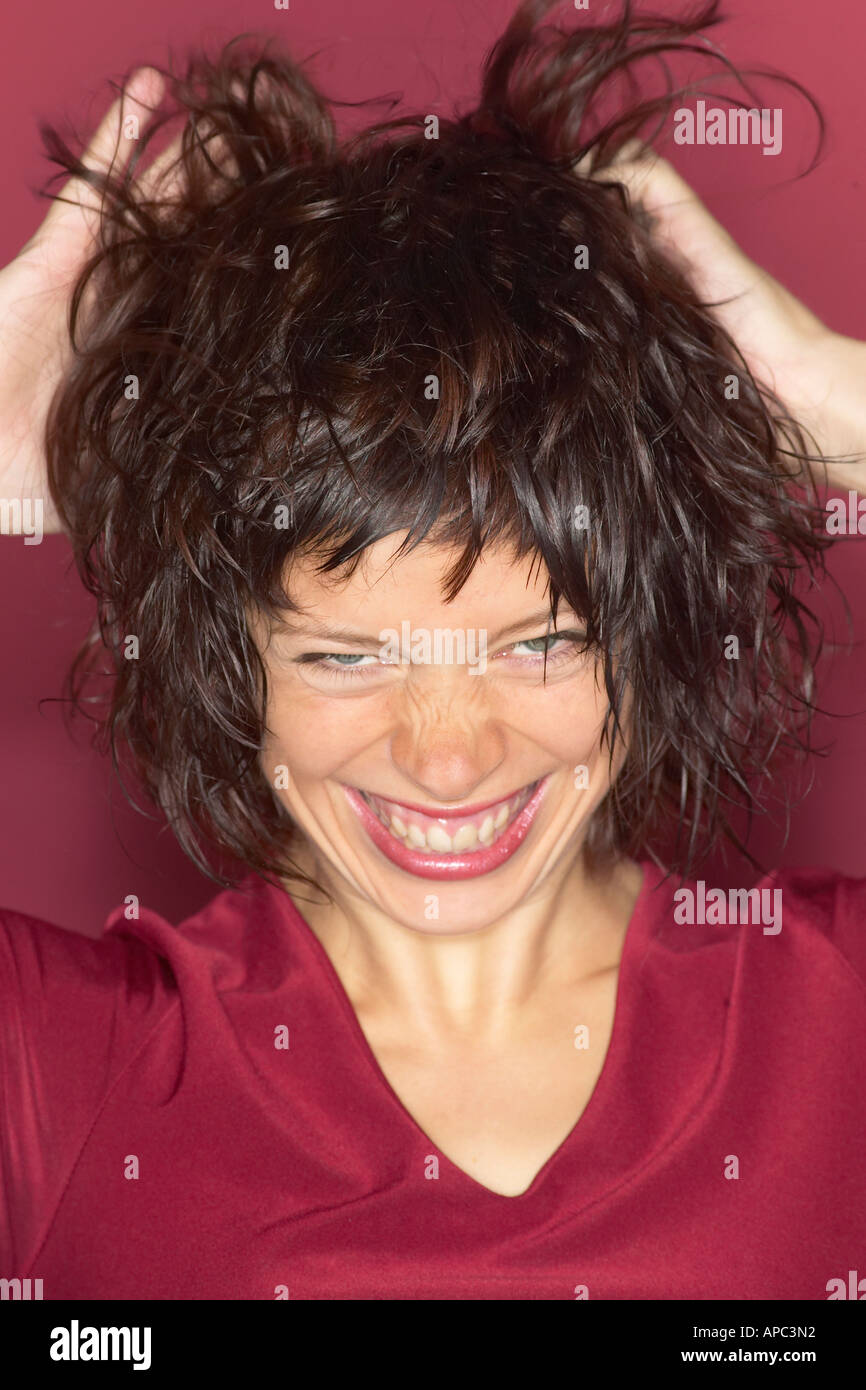 Woman running her hands through hair hi-res stock photography and ...
