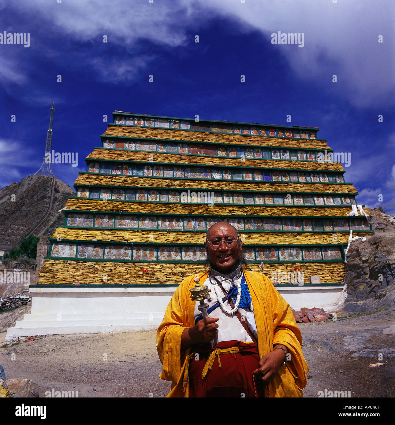 a buddhist standing in front of Mani Temple in Tibet Stock Photo - Alamy