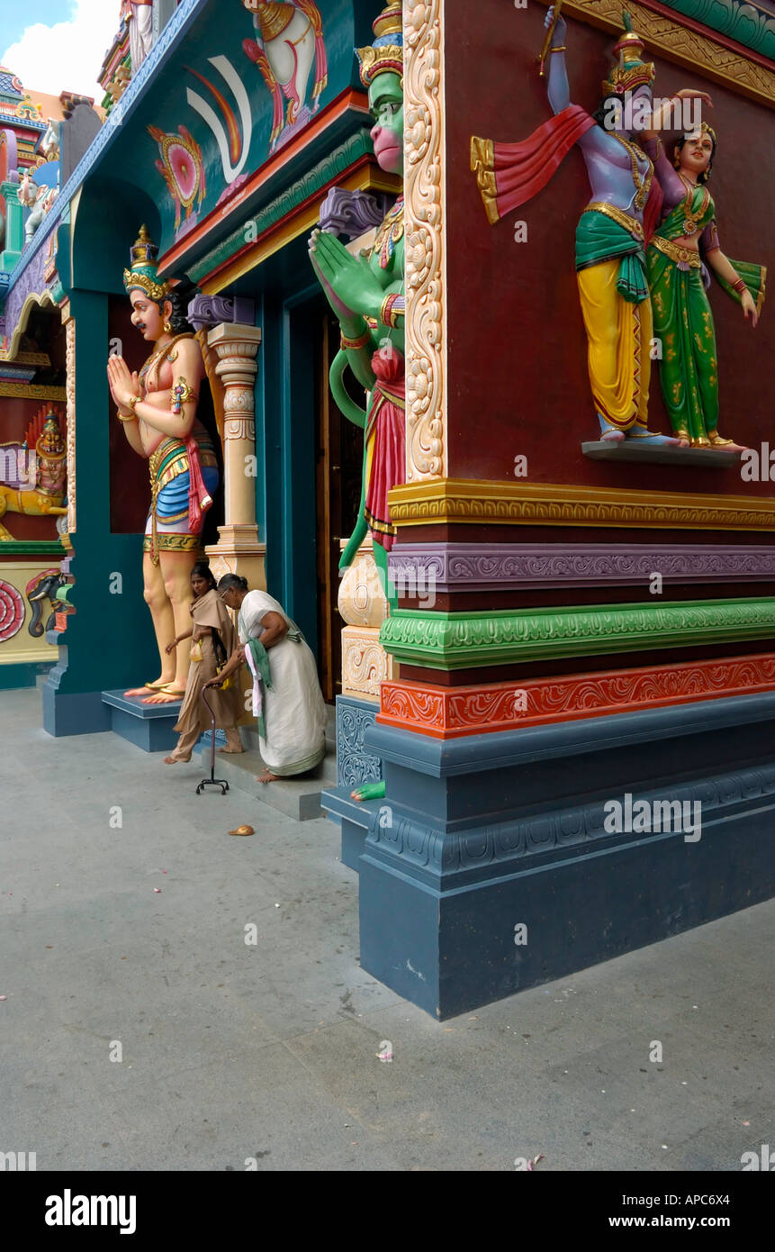 Old female devotee leaving an Indian temple after prayers Stock Photo ...