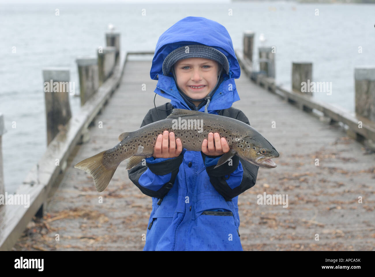 boy with fish, New Zealand Stock Photo - Alamy