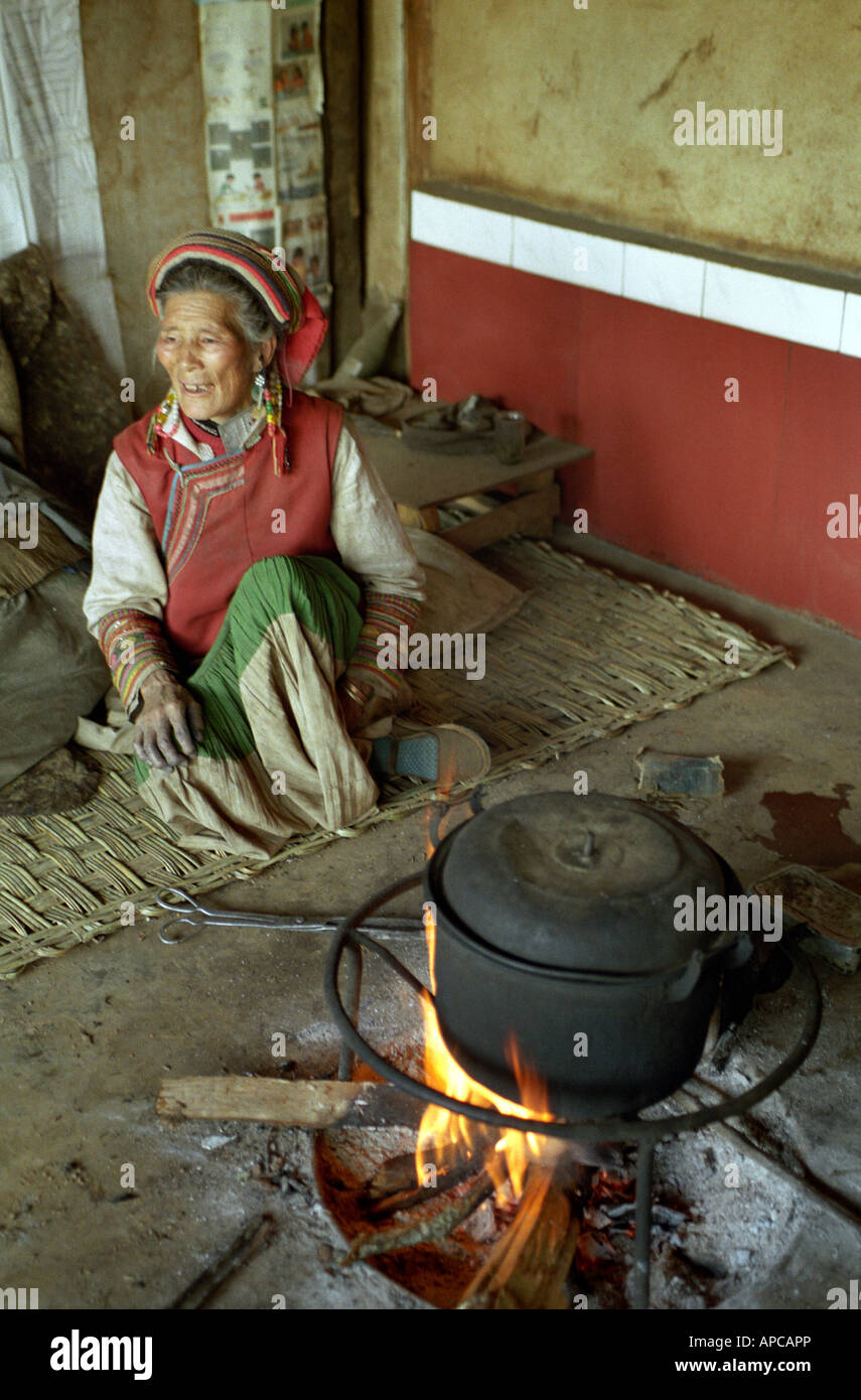 An old Yi woman cooking lunch in her small village in rural Yunnan ...