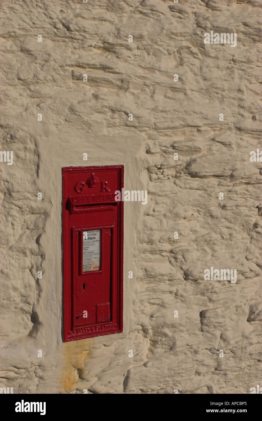 Red post box in cottage wall Stock Photo - Alamy