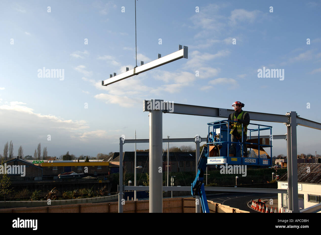 Construction workers lining up steel girder on steel fabricated ...