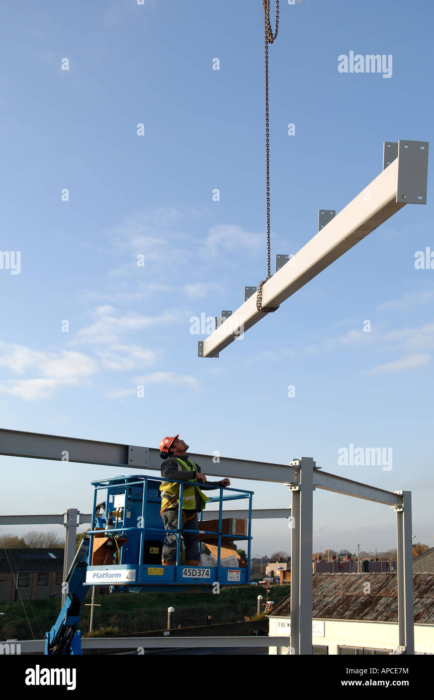 Construction workers lining up steel girder on steel fabricated ...
