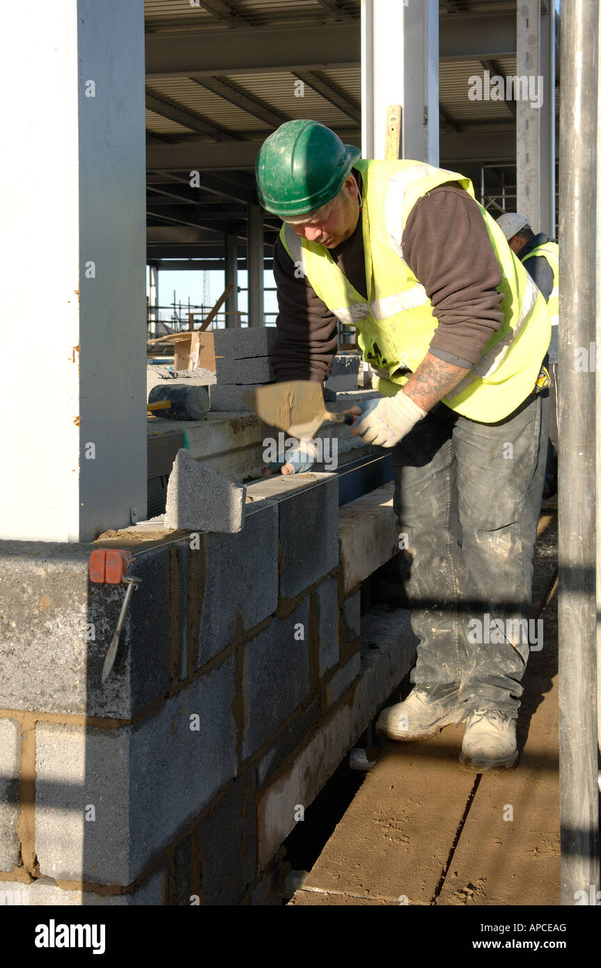 Construction worker building breeze block wall Stock Photo - Alamy
