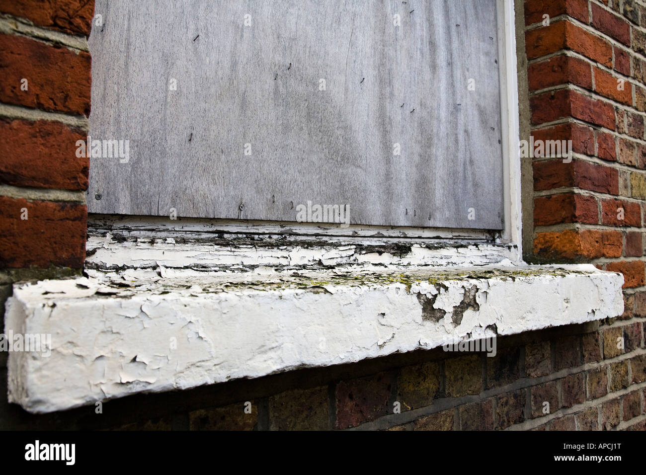 Boarded window and peeling window cill, Guildford, Surrey, England ...
