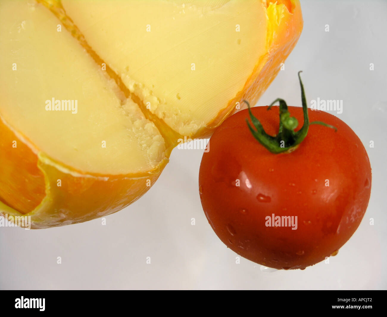 Gouda Cheese section with tomato Stock Photo - Alamy