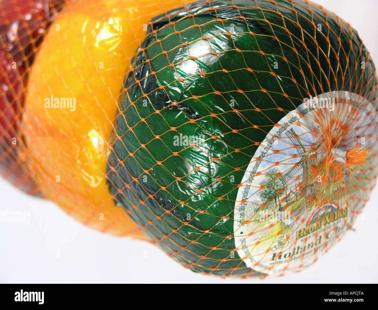 Three Gouda cheeses in a plastic net bag Stock Photo - Alamy