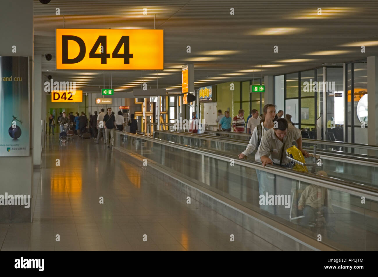 NETHERLANDS Schiphol Airport mobile walkways with gate signs Stock ...