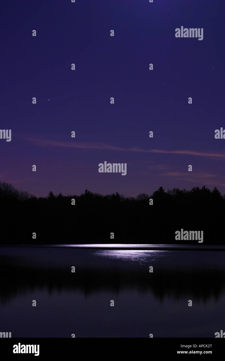 The still surface of a pond reflects the moonlight Stock Photo - Alamy