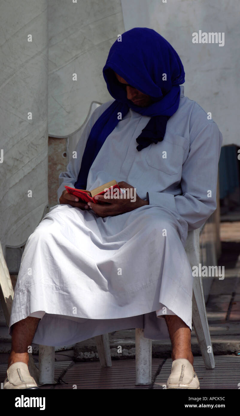 Man in shadow reading his Book Stock Photo - Alamy