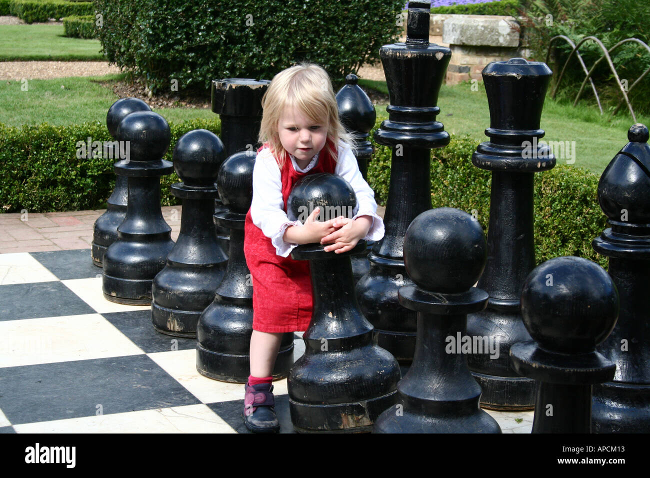 A Young Child Mastering the Giant Chess Board Stock Photo - Alamy