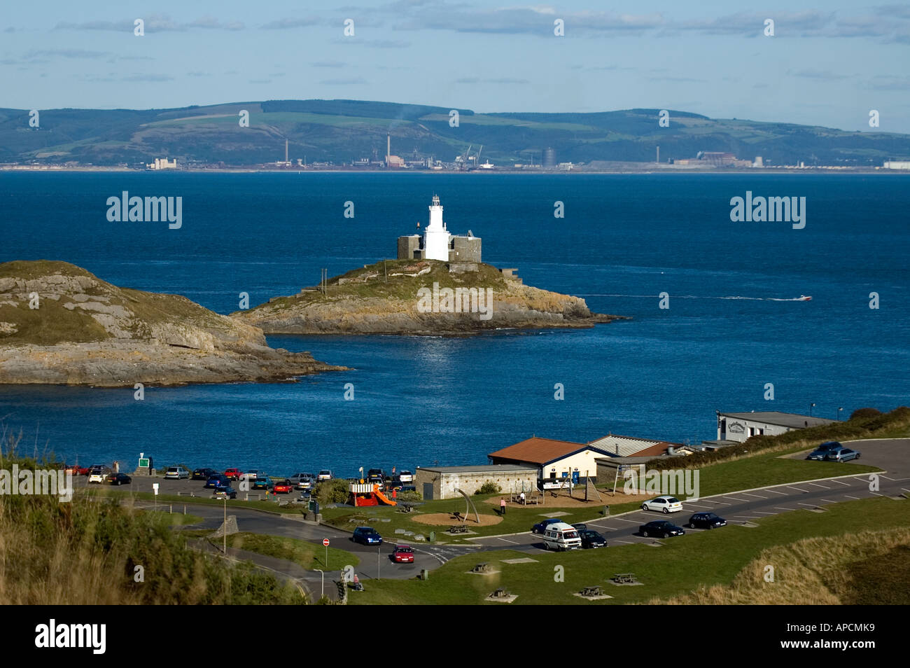 The Mumbles lighthouse with Bracelet Bay in Limeslade in the foreground ...