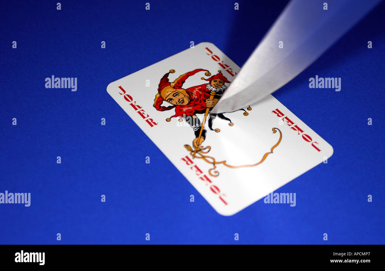 Joker playing card knife joke stab sharp held Stock Photo - Alamy