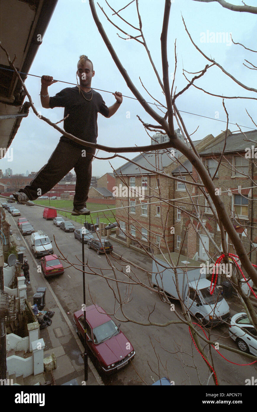 walking across rope walkway between houses St Agnes Place Squat a South ...