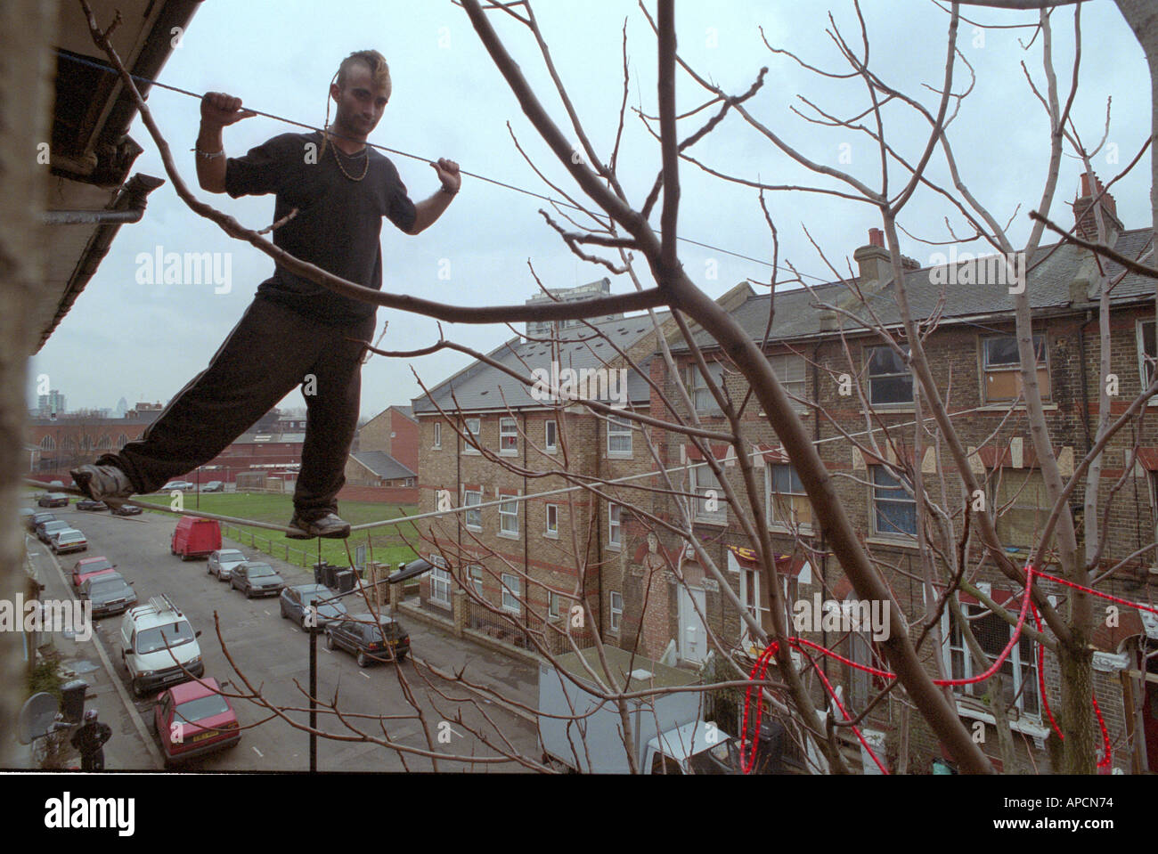 walking across rope walkway between houses St Agnes Place Squat a South ...
