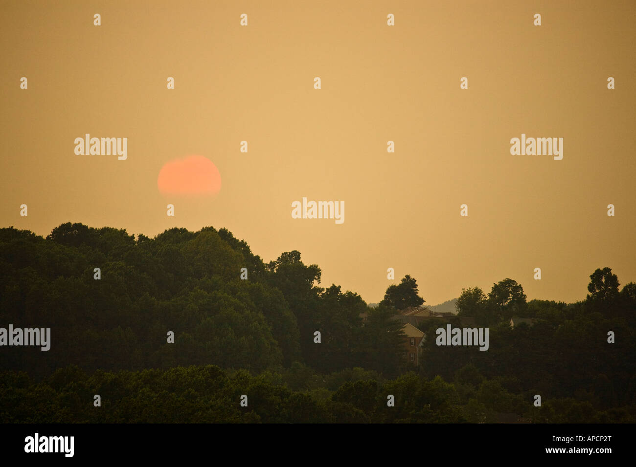 A faint sun gets ready to dip below the horizon during a late sunset ...
