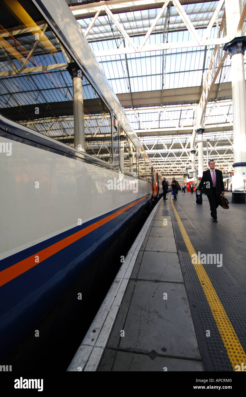 commuters on platforms next to trains at waterloo mainline station ...