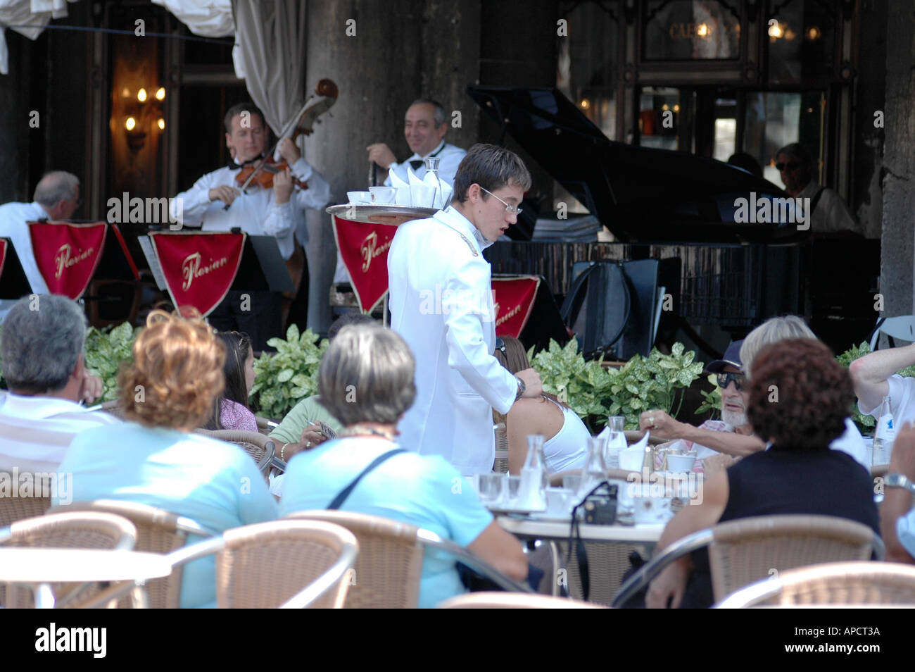 Waiter at work serving people in St Marks square Stock Photo - Alamy