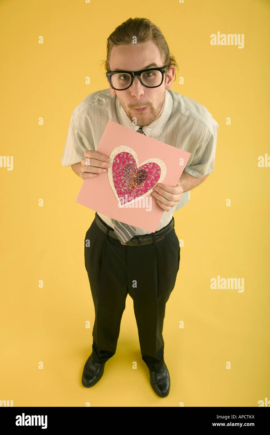 Awkward young suitor with Valentine’s Day card Stock Photo - Alamy